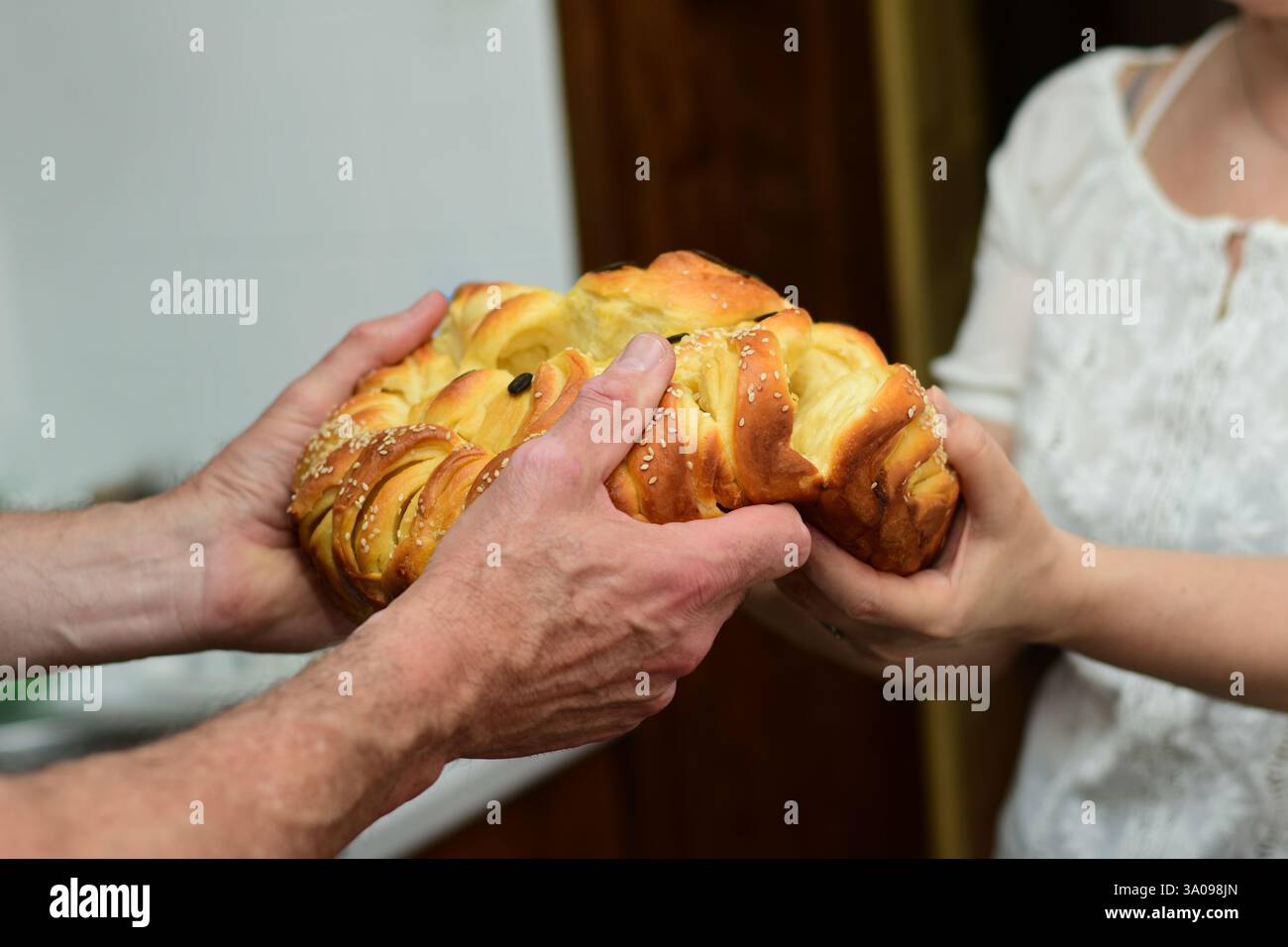 Man and woman sharing bread, part of orthodox slava traditional ritual ...