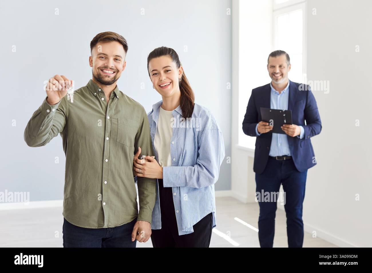 Portrait Of Happy Family Couple Celebrating New Property Purchase Stock ...