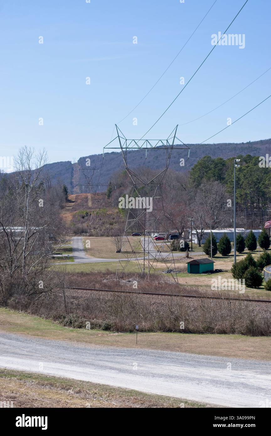 Power lines in a rural setting cutting through a hillside Stock Photo ...