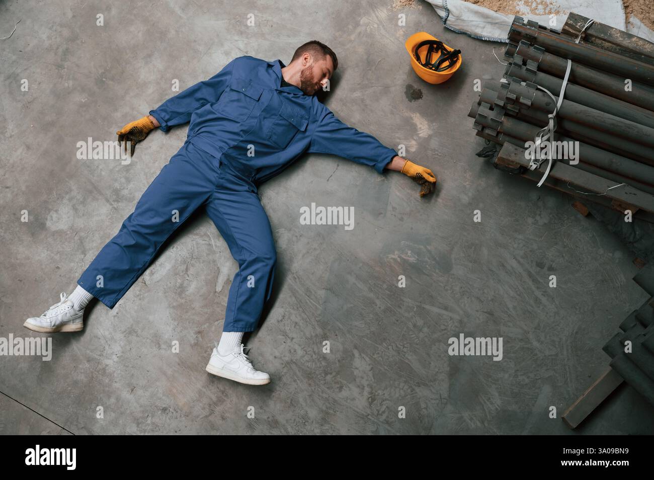 Top view of dead factory worker that lying on the ground. Conception of ...