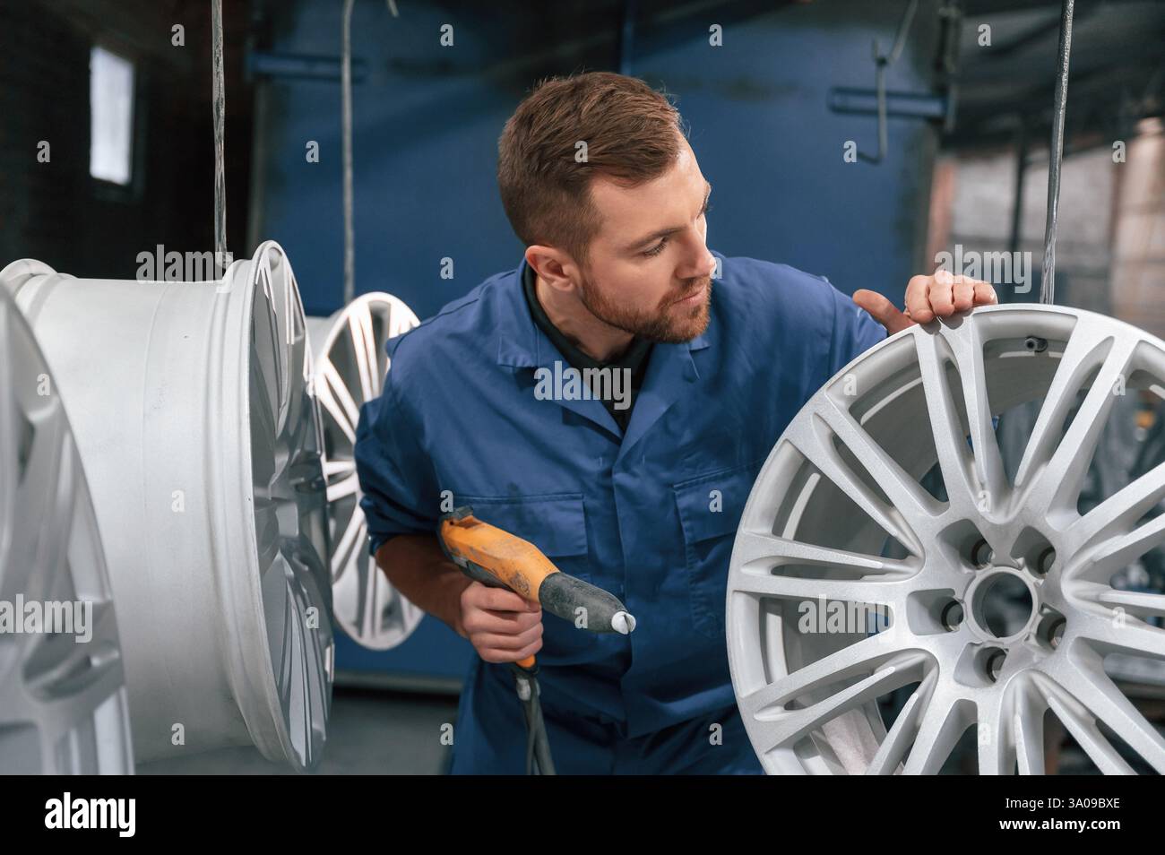 Holding equipment. Ready to adjust the wheel. Car service station ...