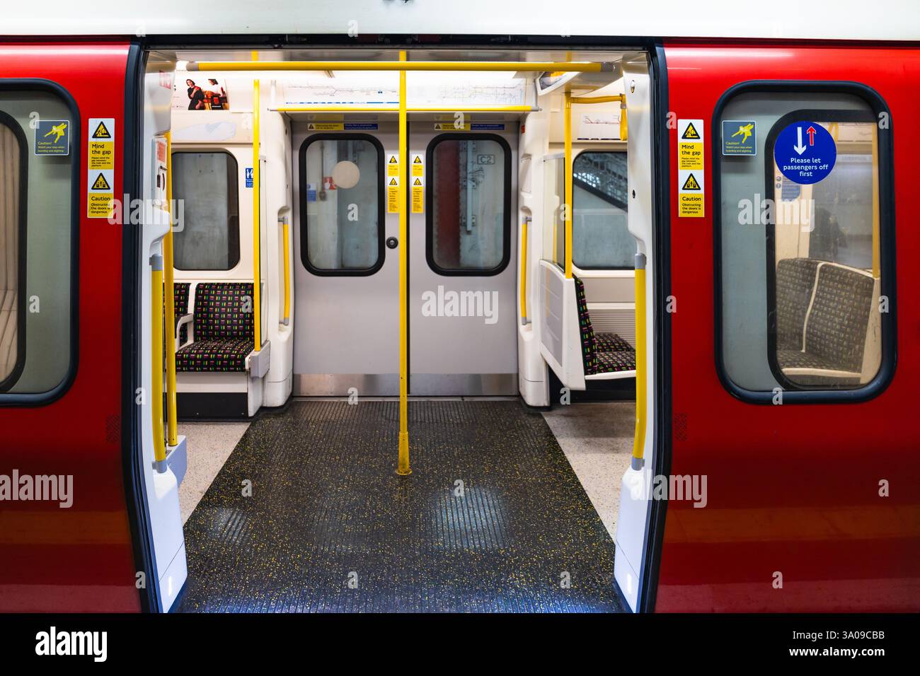 Open doors of a London Underground train showing the interior seating ...