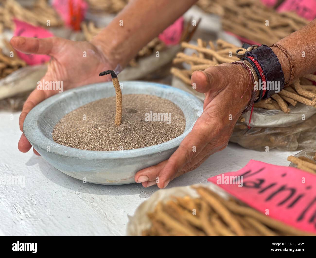 closeup of handmade incense sticks at street market outdoors with hands ...