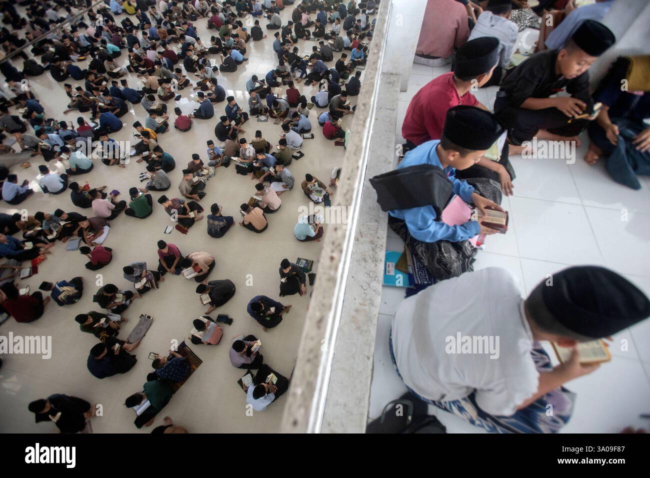 Students sit in circles as they read the Quran during the holy fasting ...