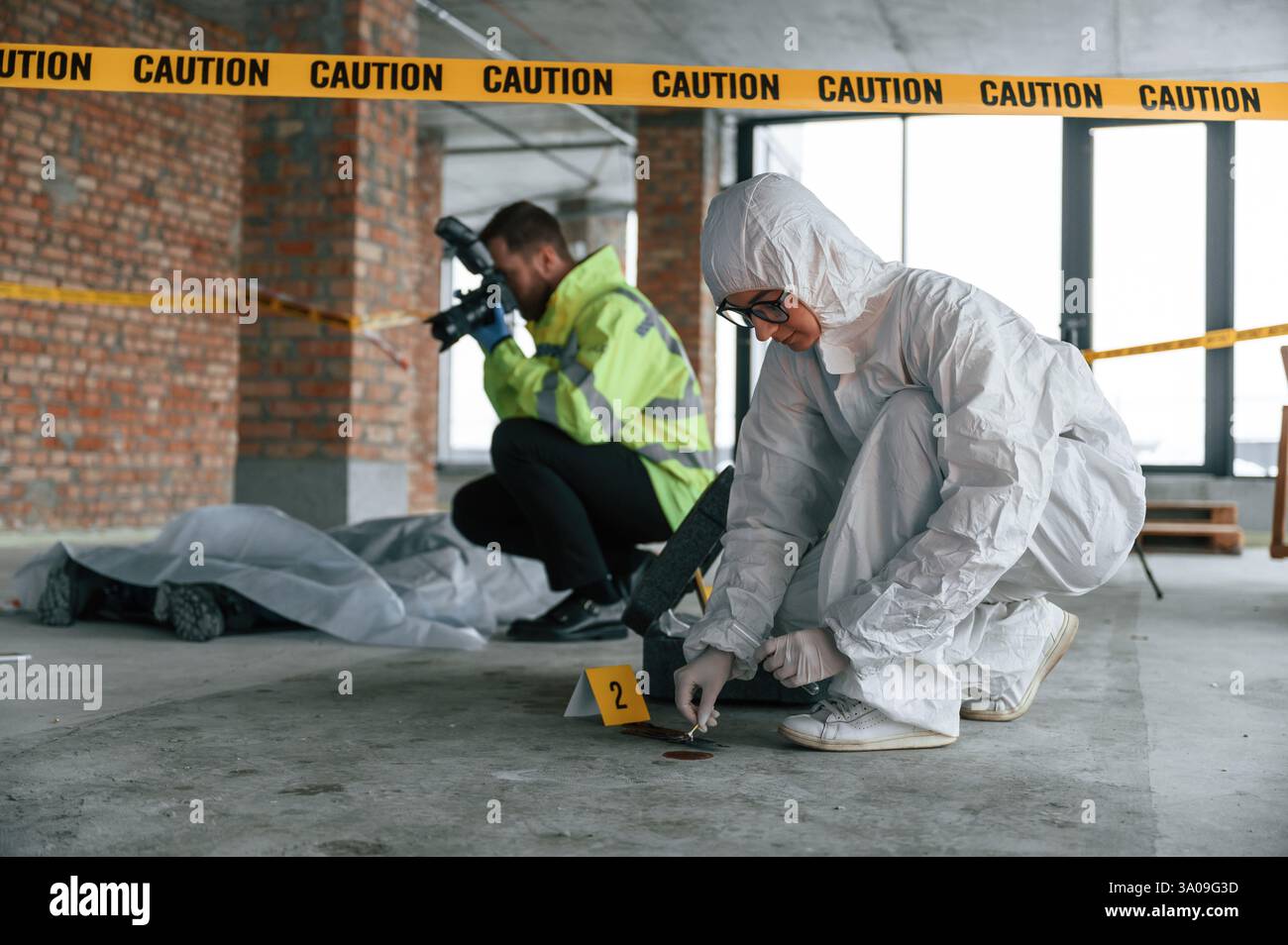 Knive and blood is on the ground. Detectives are collecting evidence in ...