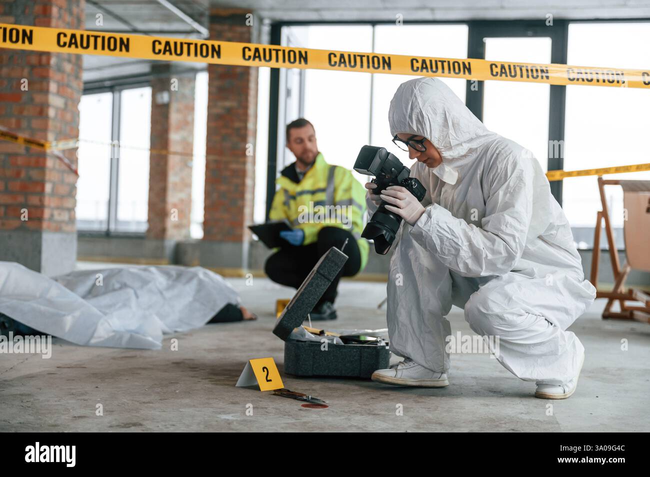 Knive and blood is on the ground. Detectives are collecting evidence in ...