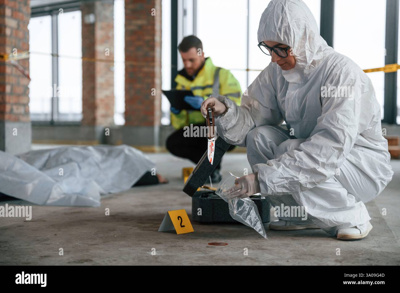 Knive and blood is on the ground. Detectives are collecting evidence in ...