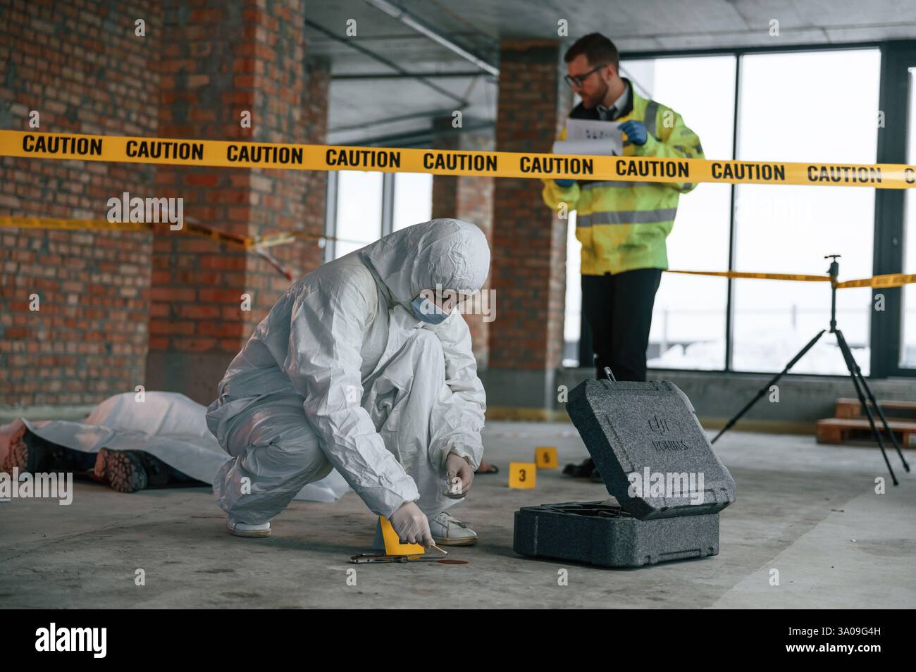 Knife as evidence. Blood is on the floor. Detectives are in a crime ...