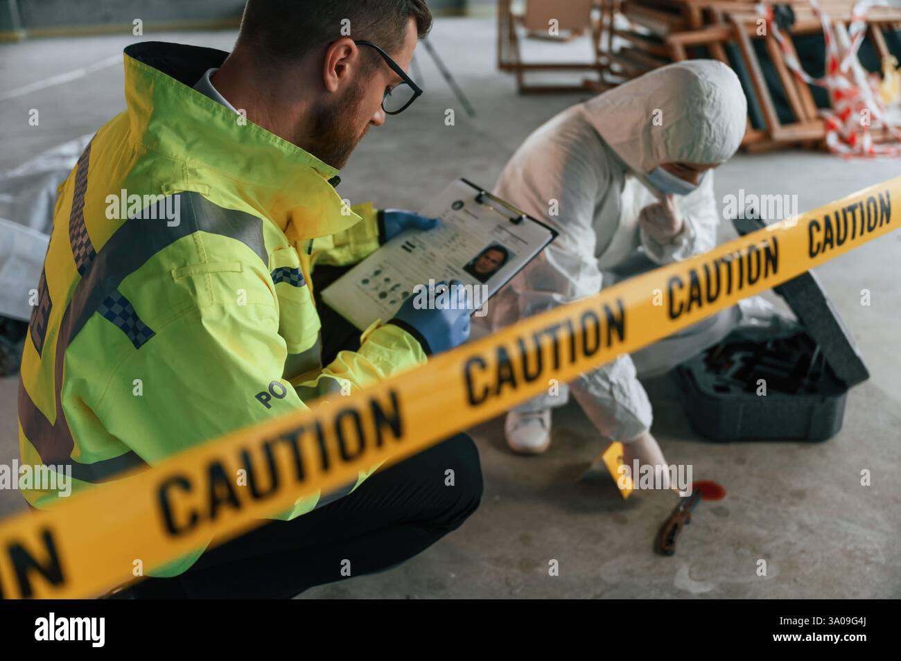 Caution police tape. Detectives are collecting evidence in a crime ...