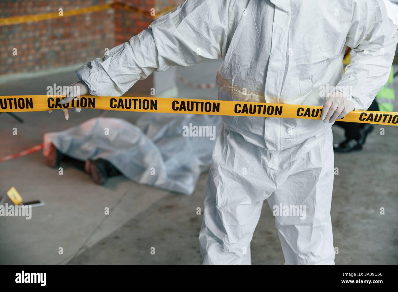 Holding caution police tape. Detectives are collecting evidence in a ...