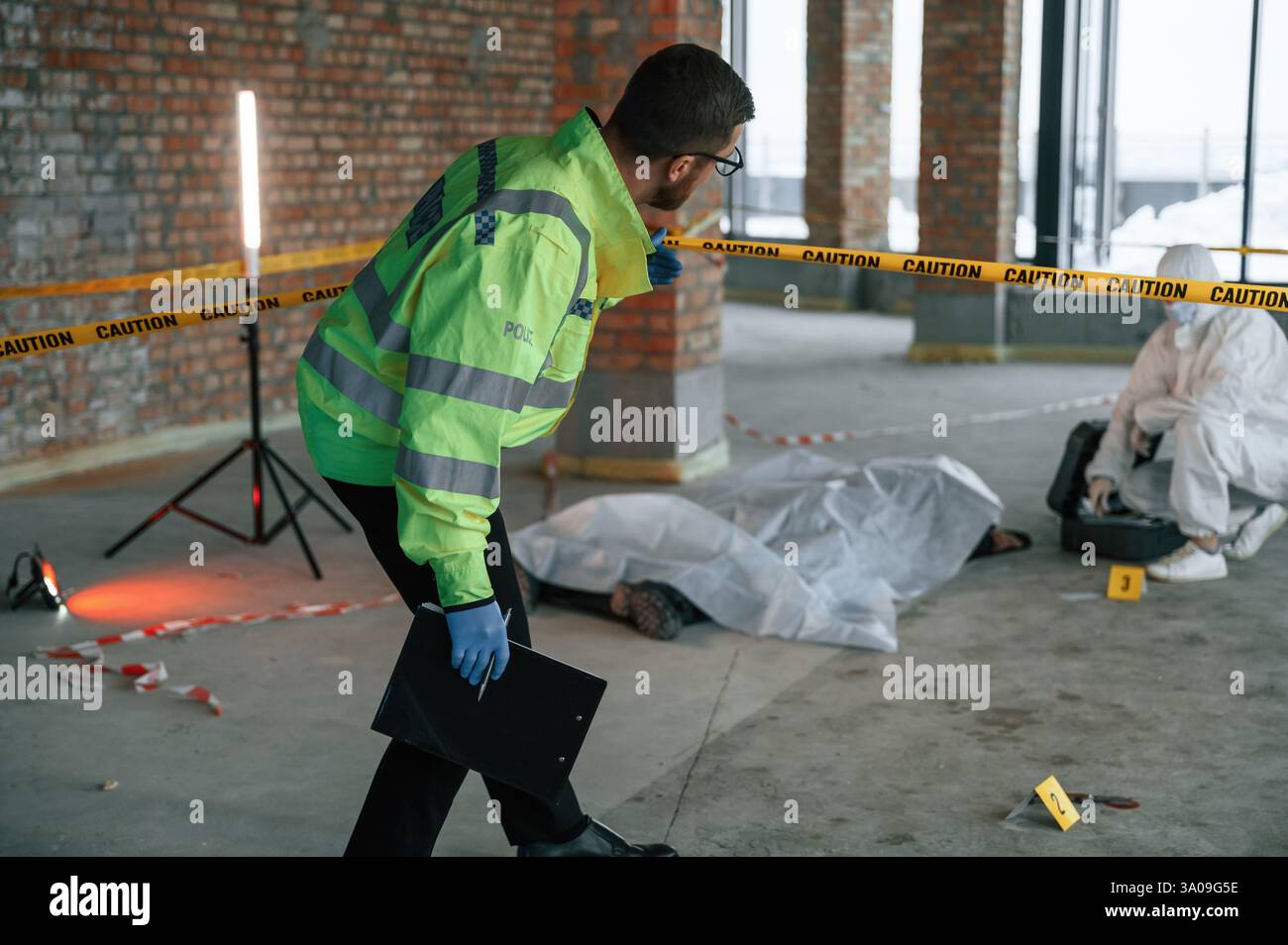 Detectives are collecting evidence in a crime scene near dead body ...