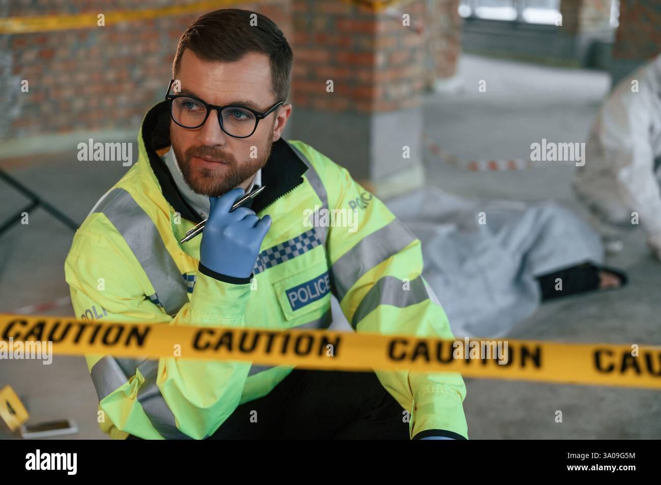 Sitting near caution police tape. Detectives are collecting evidence in ...