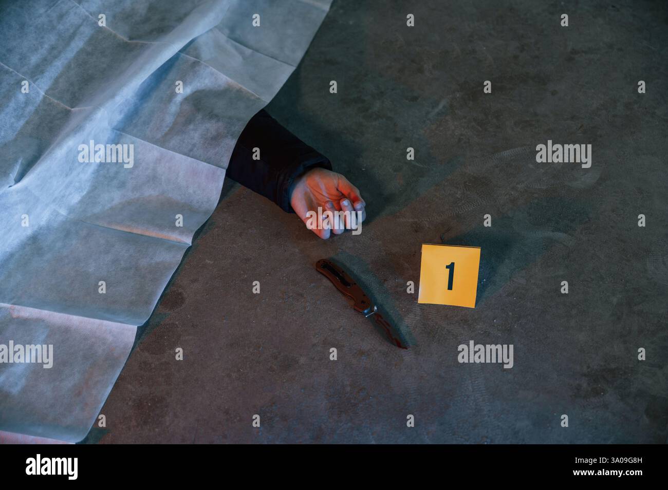 Dead body of a man is on the ground, covered in white cloth. Conception ...