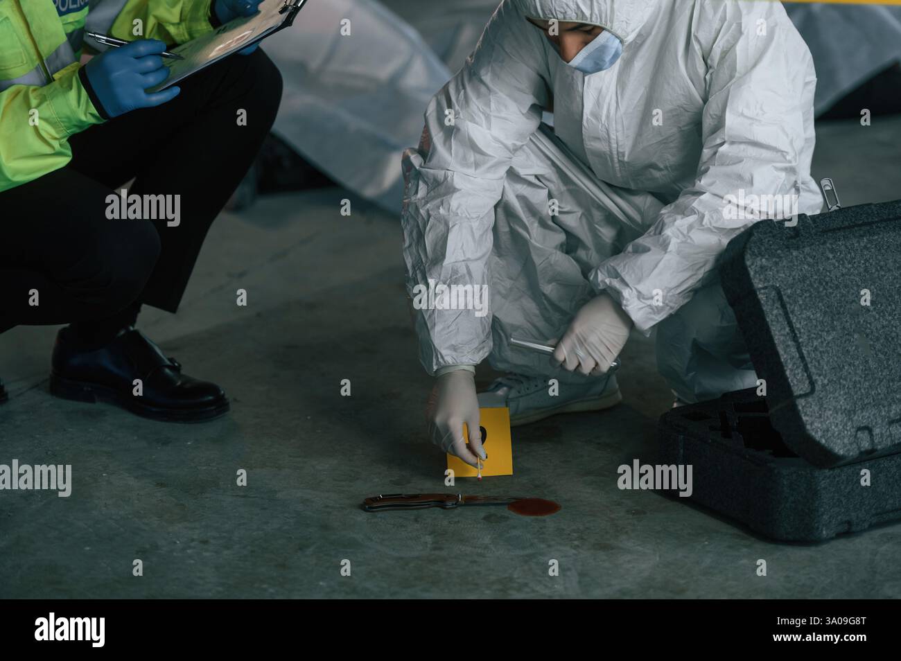 Detectives are collecting evidence in a crime scene near dead body ...