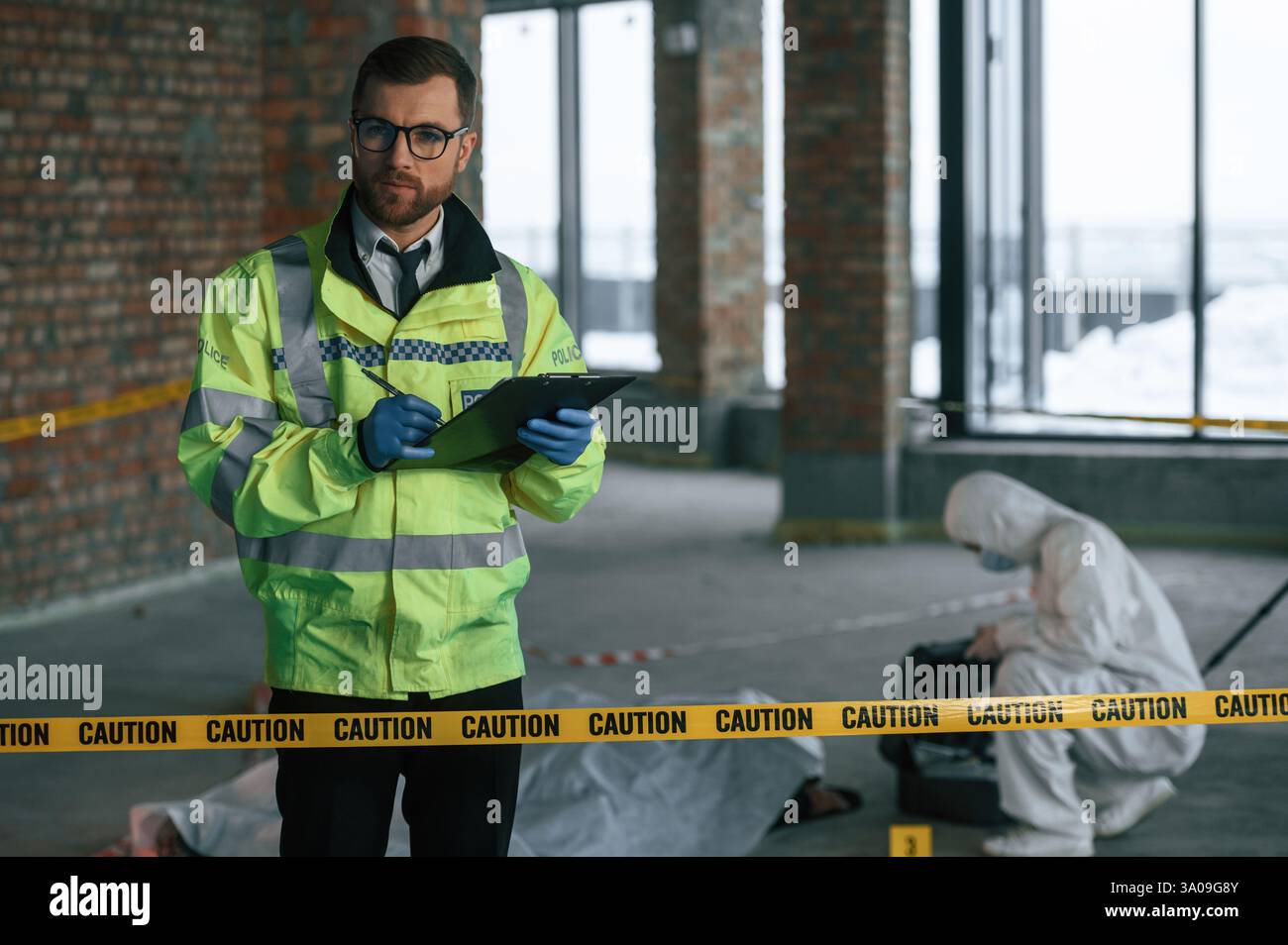 At daytime. Detectives are collecting evidence in a crime scene near ...