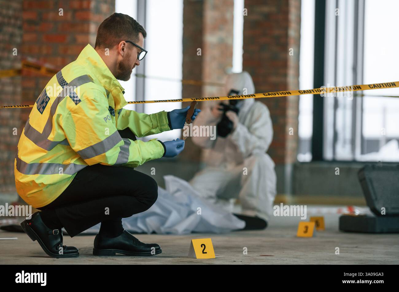 Woman is using camera, making photos. Detectives are collecting ...