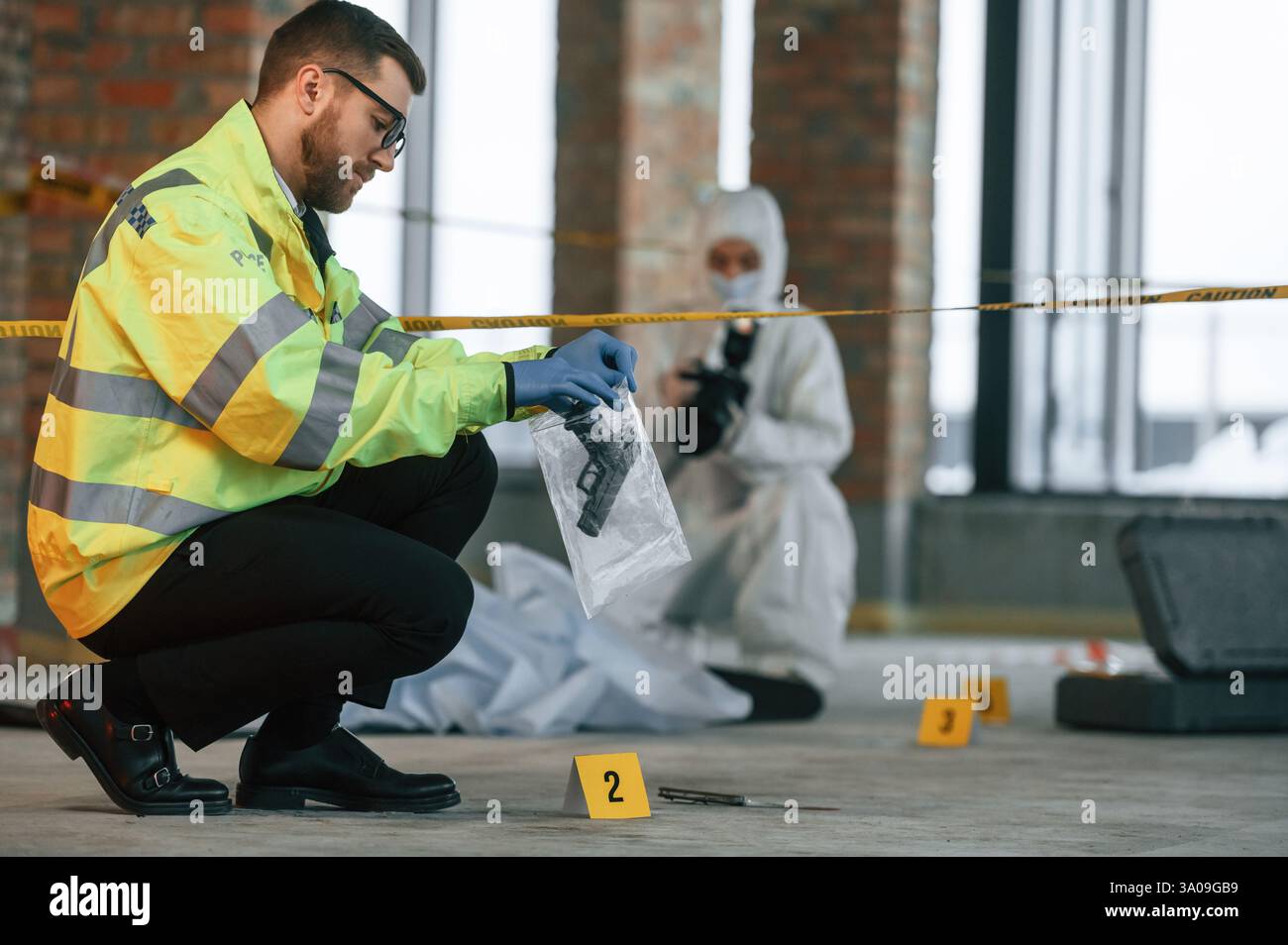 Woman is using camera, making photos. Detectives are collecting ...