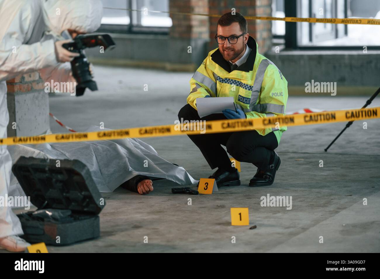 Woman is making photos by camera. Detectives are collecting evidence in ...
