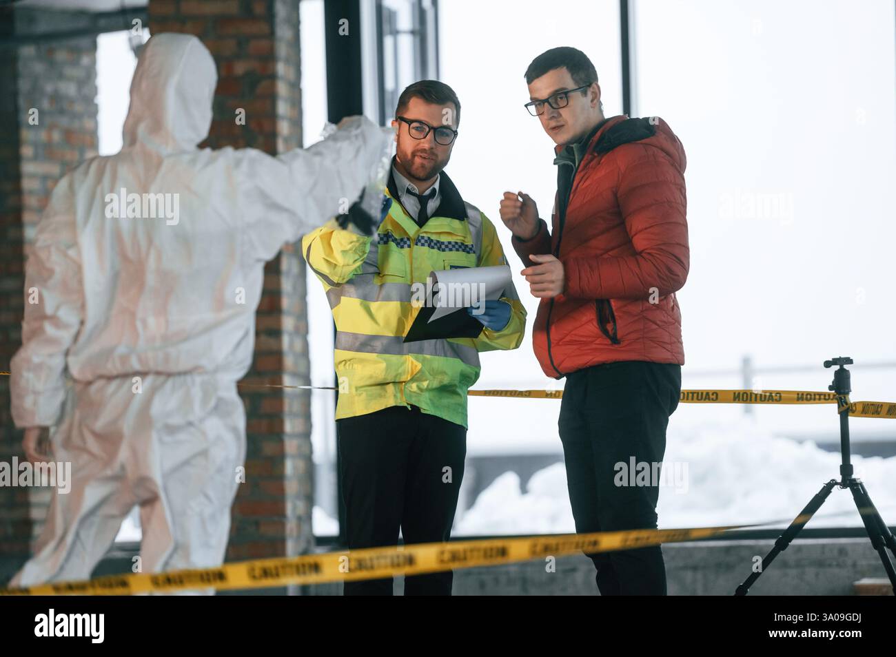 The witness is being questioned. Two detectives are collecting evidence ...