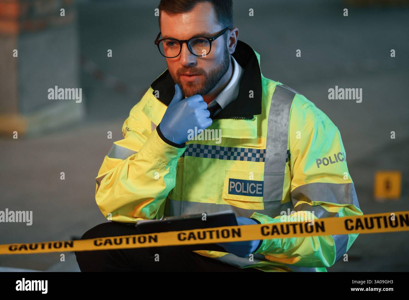 Sitting and thinking. Male detective is collecting evidence in a crime ...