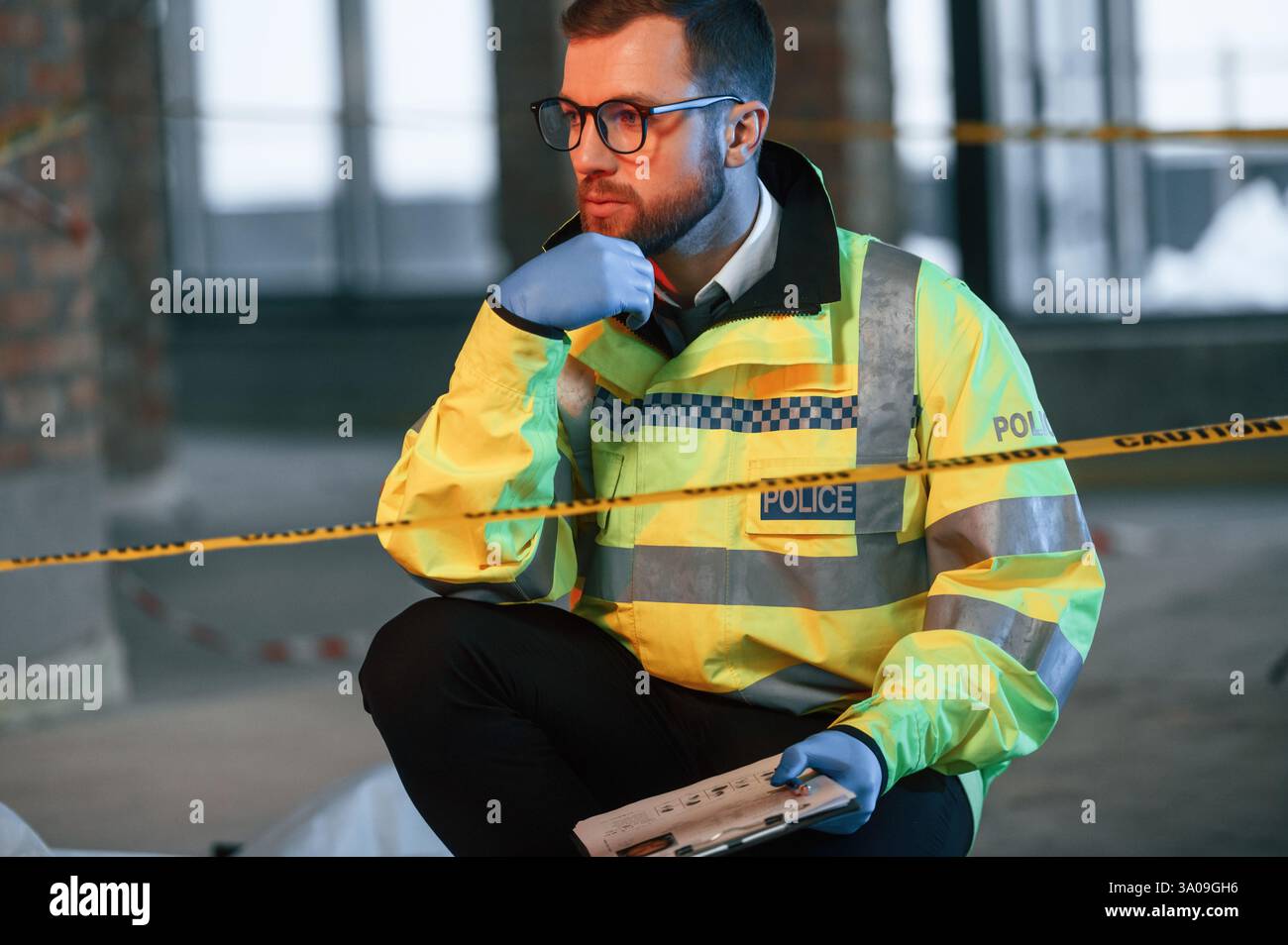 Sitting and thinking. Male detective is collecting evidence in a crime ...