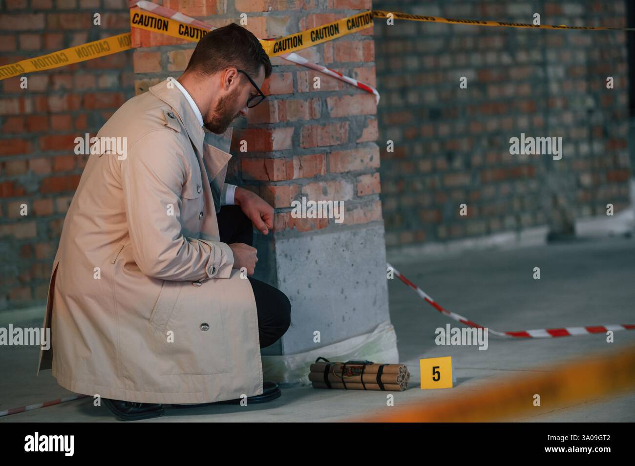 Detective in coat is on the crime scene with explosive bomb Stock Photo ...