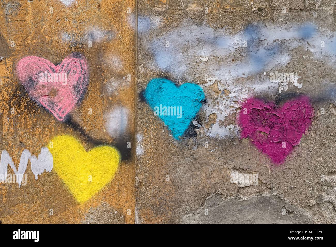 Colorful heart graffiti on weathered wall. Vibrant hearts in various ...