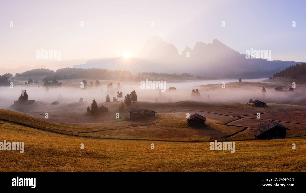 Fog over mountain huts in autumn, Seiser Alm Stock Photo - Alamy