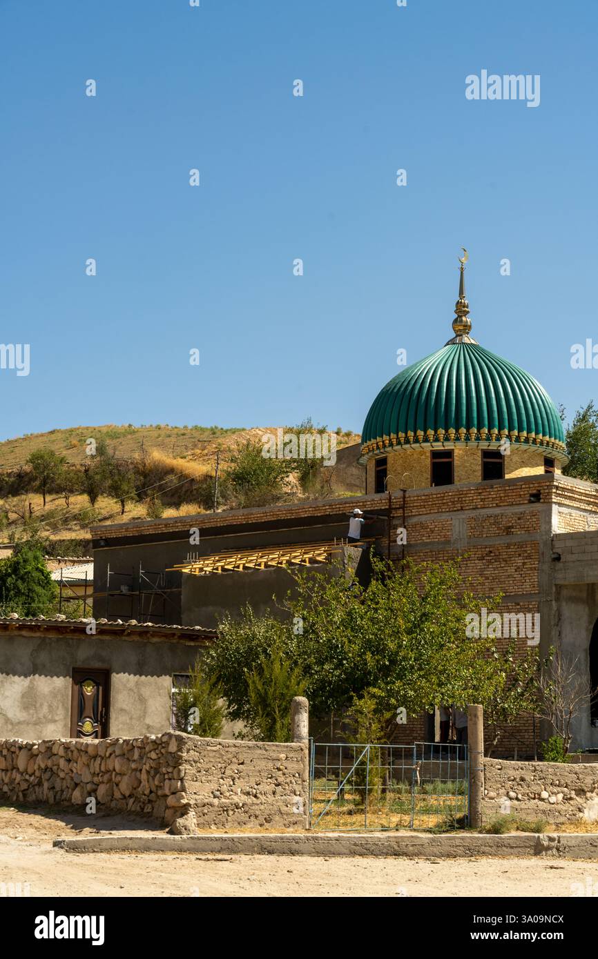 A green dome on a building with a blue roof Stock Photo - Alamy