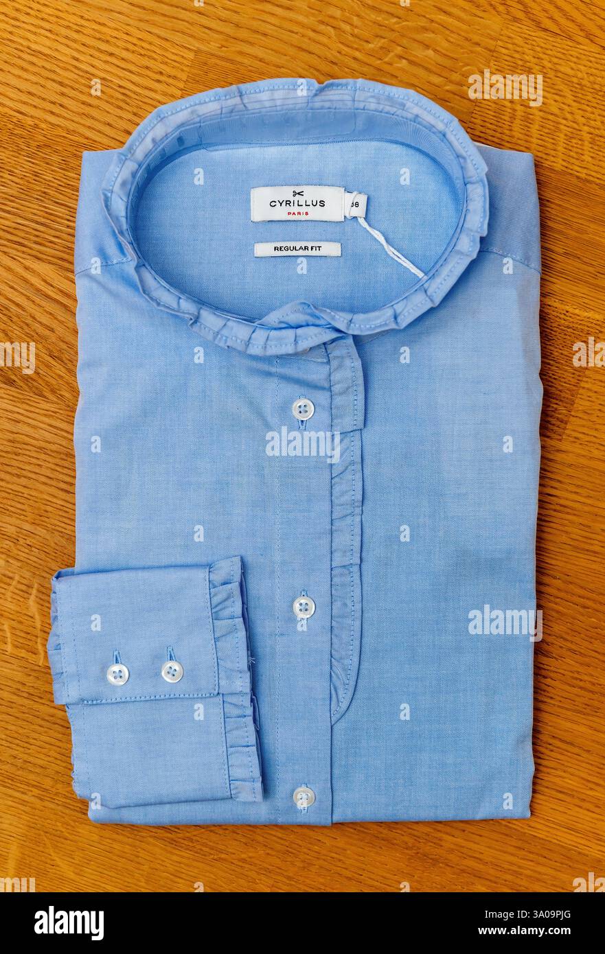 Paris, France - Feb 12, 2025: Neatly folded blue Cyrillus Paris shirt ...