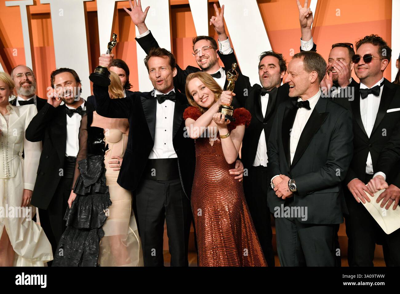 Victoria Warmerdam, center in red, arrives at the Vanity Fair Oscar ...