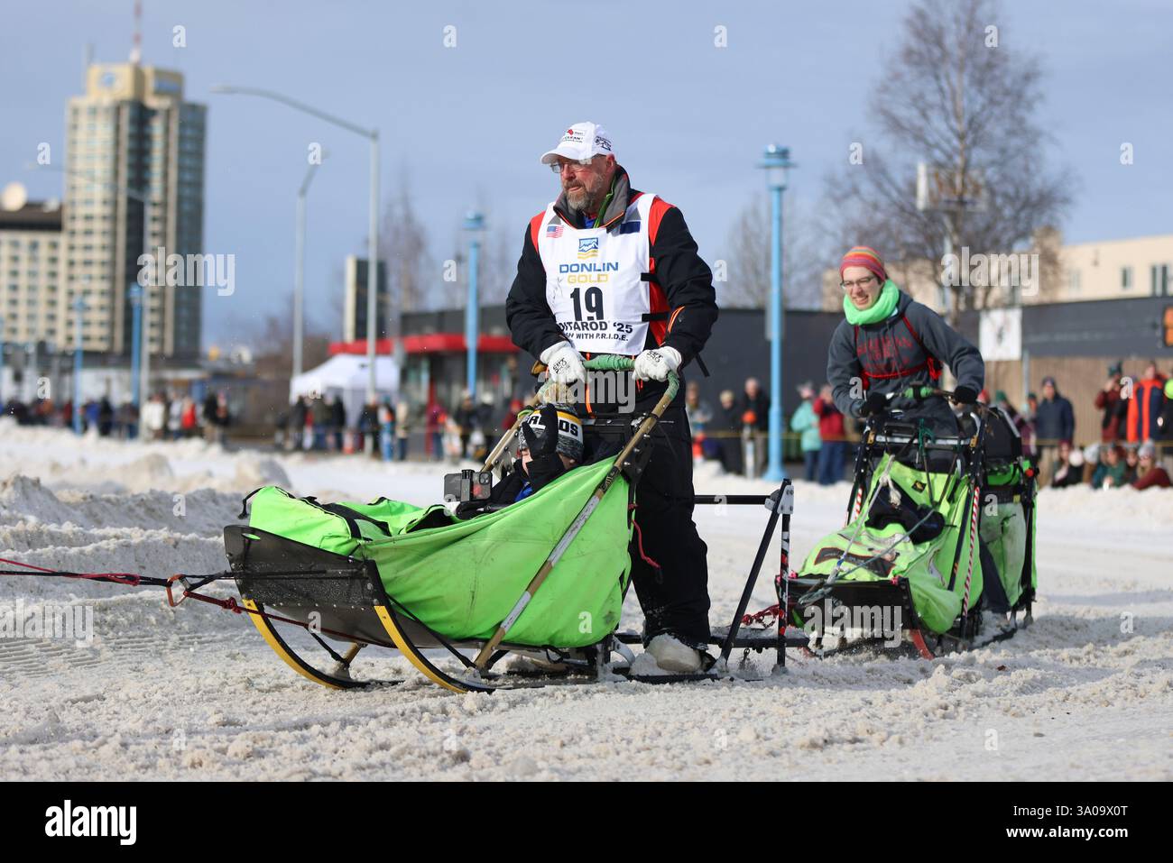 Daniel Klein (19), of Eagle, Wisconsin, mushes through downtown during ...