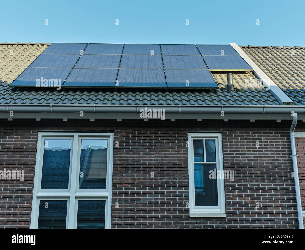 A modern house in Assen, Netherlands, with solar panels on the tiled ...