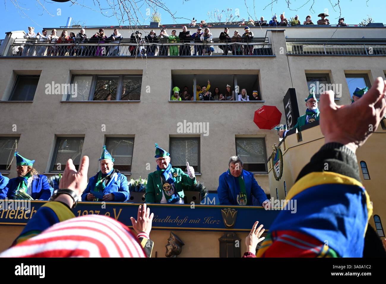 03 March 2025, North Rhine-Westphalia, Cologne: Carnival revelers throw ...