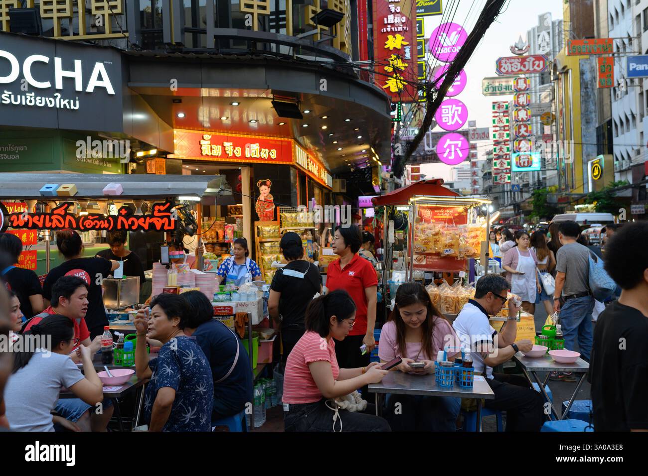 Bangkok, Thailand. February 18th 2025. Busy evening crowds at popular street food stalls along ...