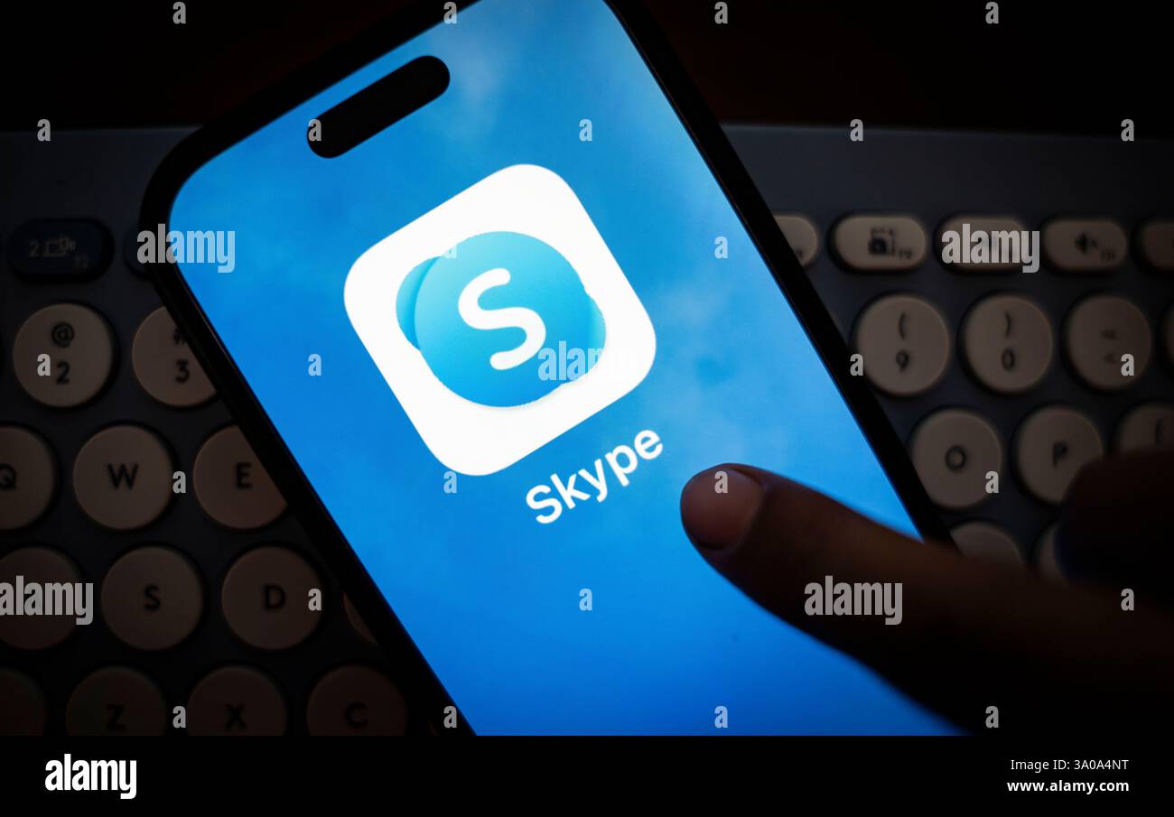 March 3, 2025: In this photo illustration, a person holds a mobile phone displaying Skype ...