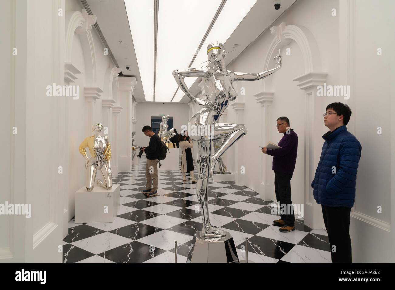 People tour an exhibition of the works by Japanese artist Hajime ...