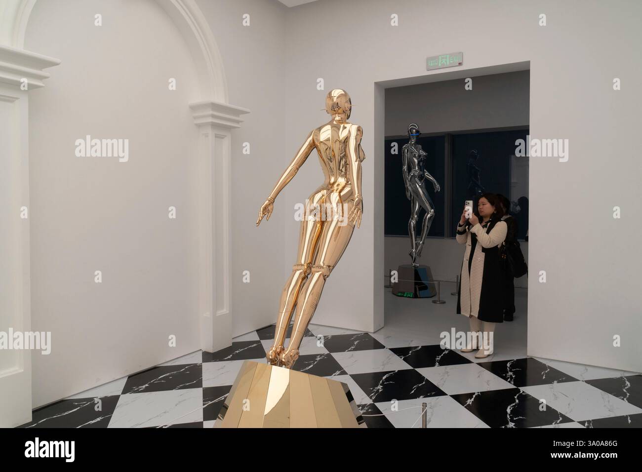 A woman tours an exhibition of the works by Japanese artist Hajime ...