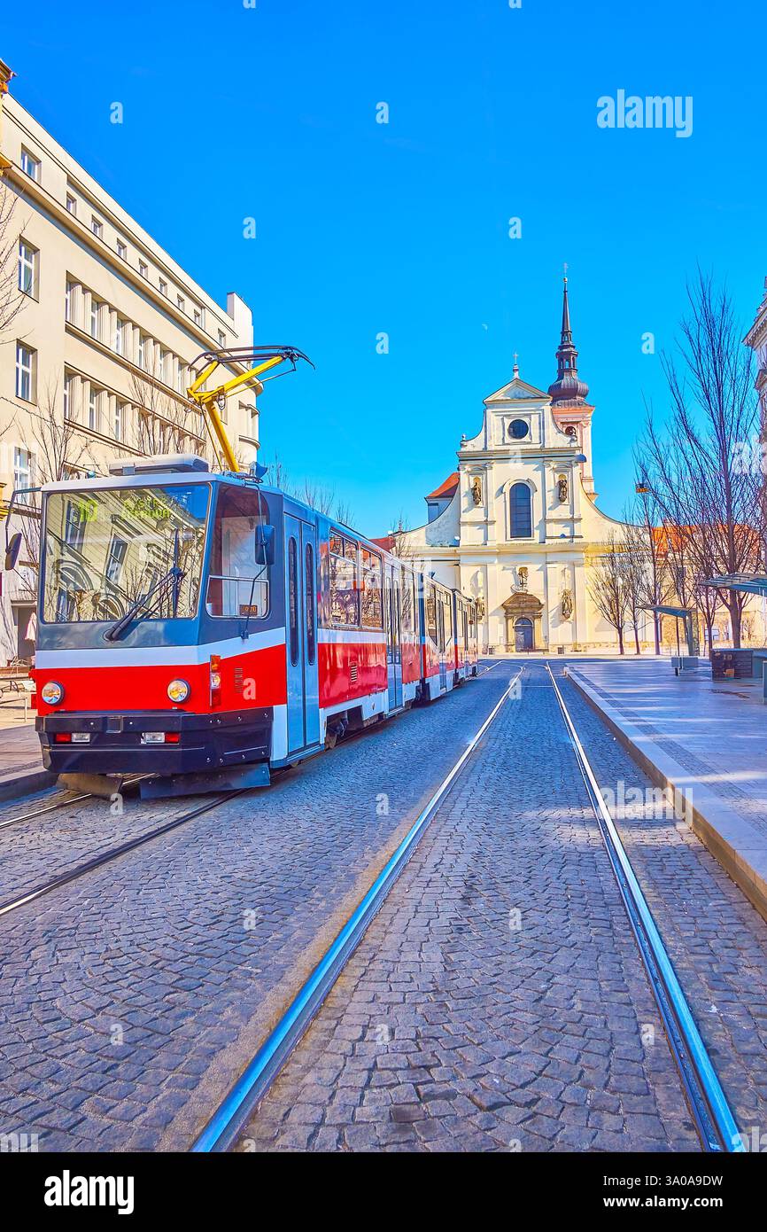 The vintage tram rides along Church of St. Thomas and Jostova street in ...