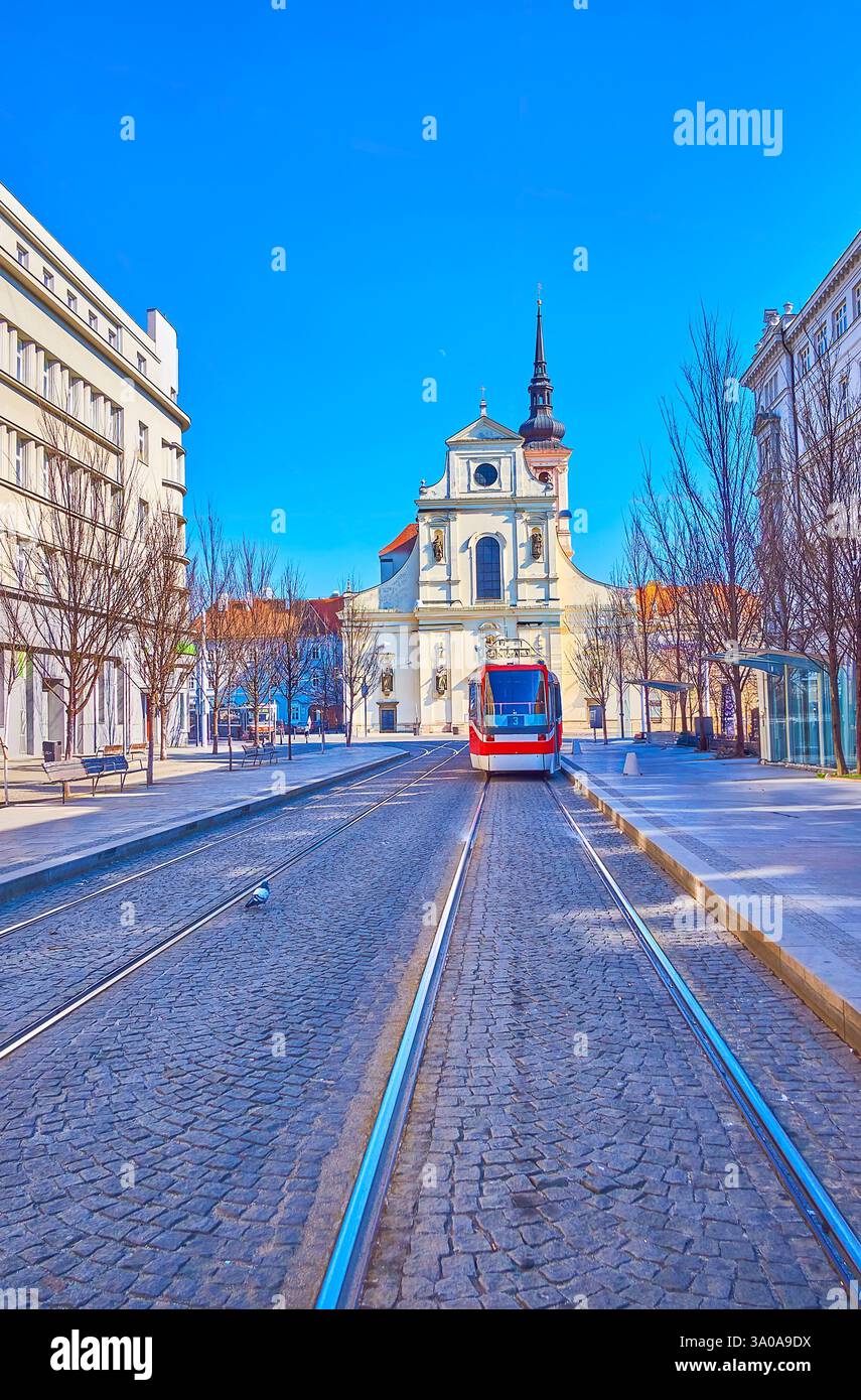 Modern tram in central neighborhood of Brno with Church of St. Thomas ...