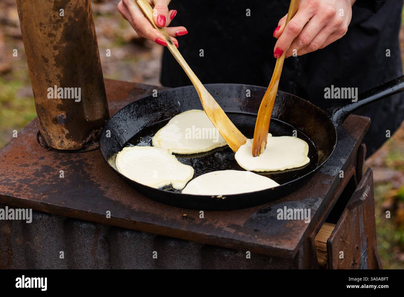 Preparing blini, blin or blynai, pancakes traditionally made from wheat ...