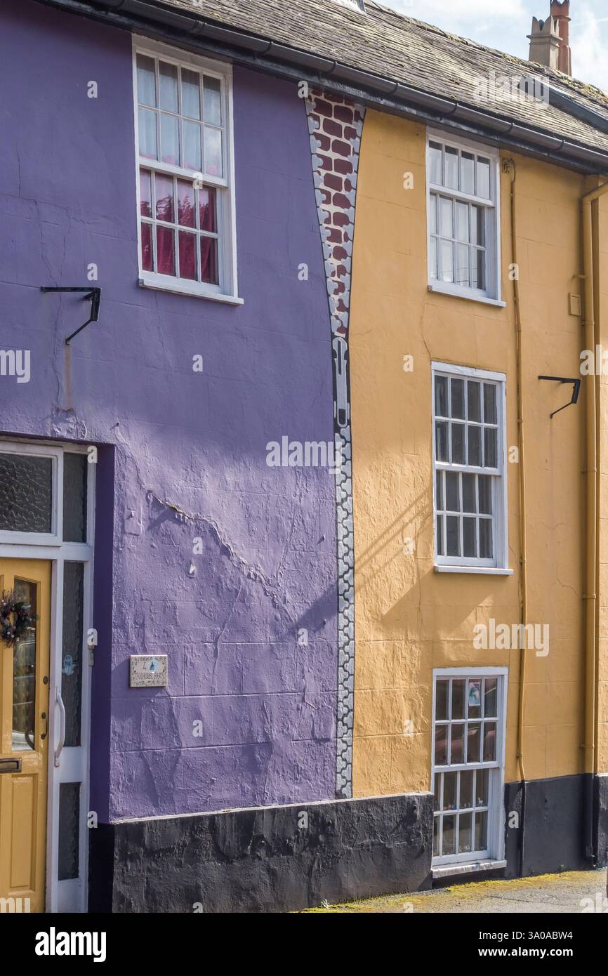 Two brightly coloured houses apparently joined together by a painted ...