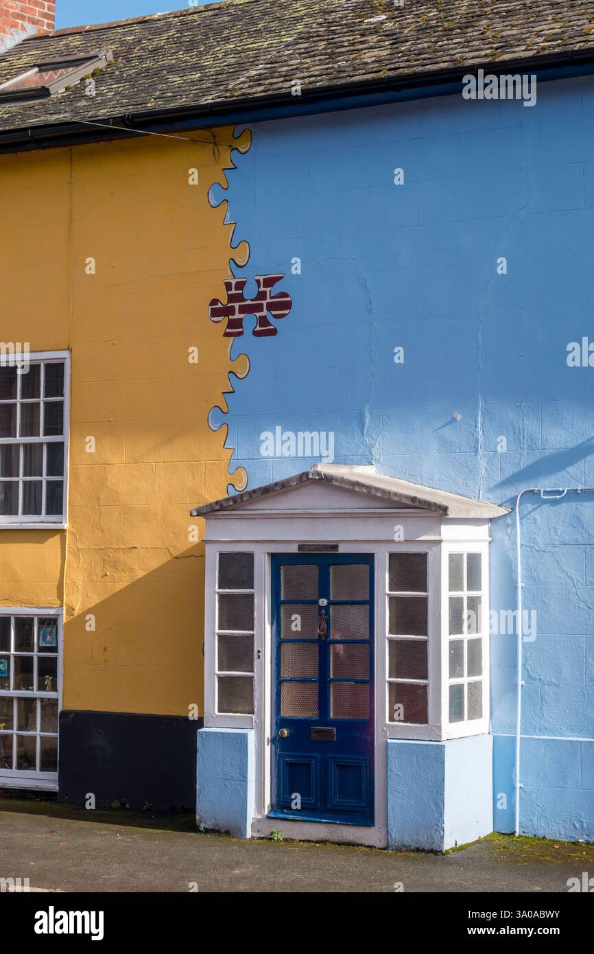 Two brightly coloured houses apparently joined together as a jigsaw ...