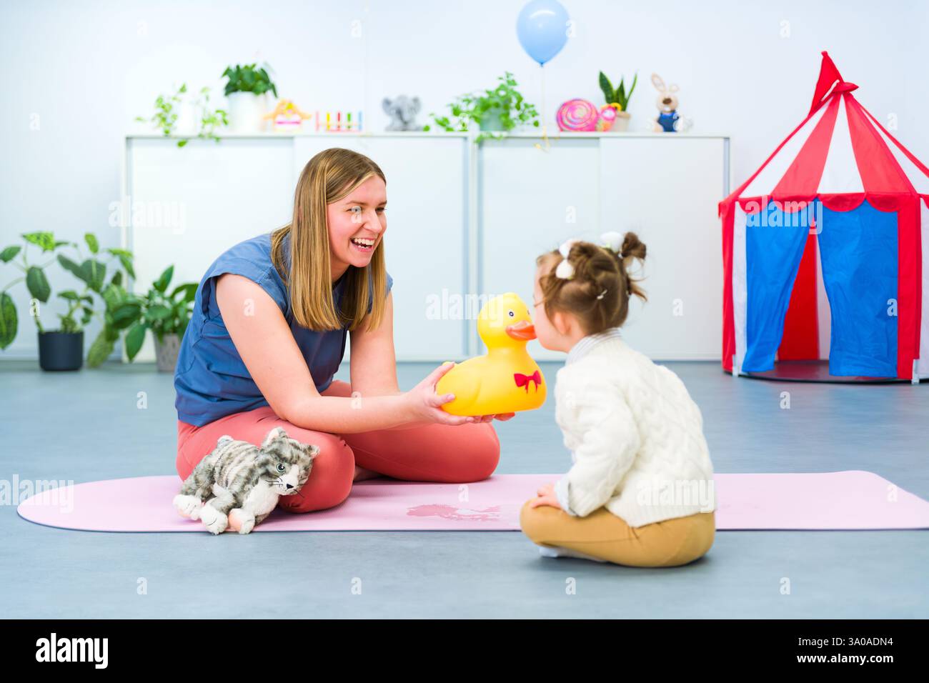 Toddler girl in child occupational therapy session doing sensory ...