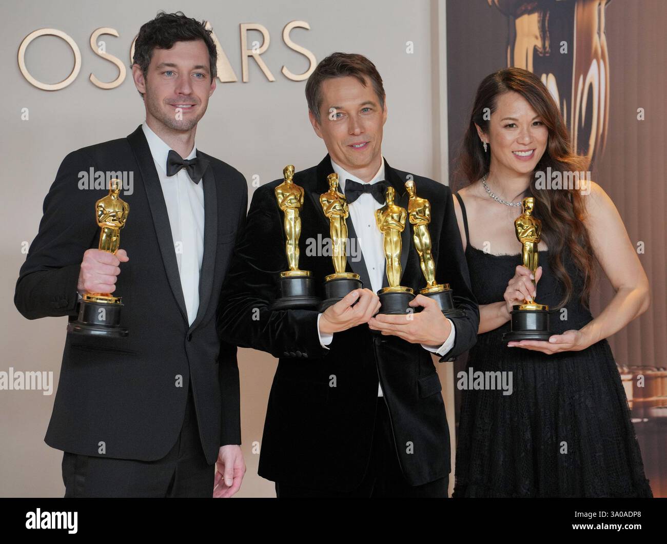 (L-R) Alex Coco, Sean Baker, and Samantha Quan, winners of the Best Picture for “Anora”, posing ...