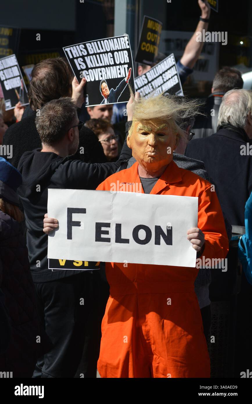 Person dressed as Donald Trump in a prison jumpsuit at a protest ...