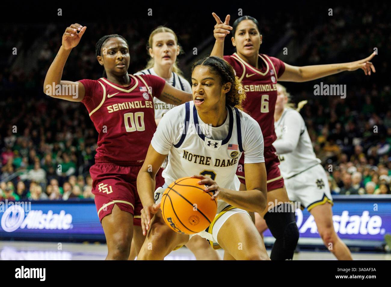 Notre Dame guard Cassandre Prosper (8) grabs the rebound around Florida State guard Ta'Niya ...