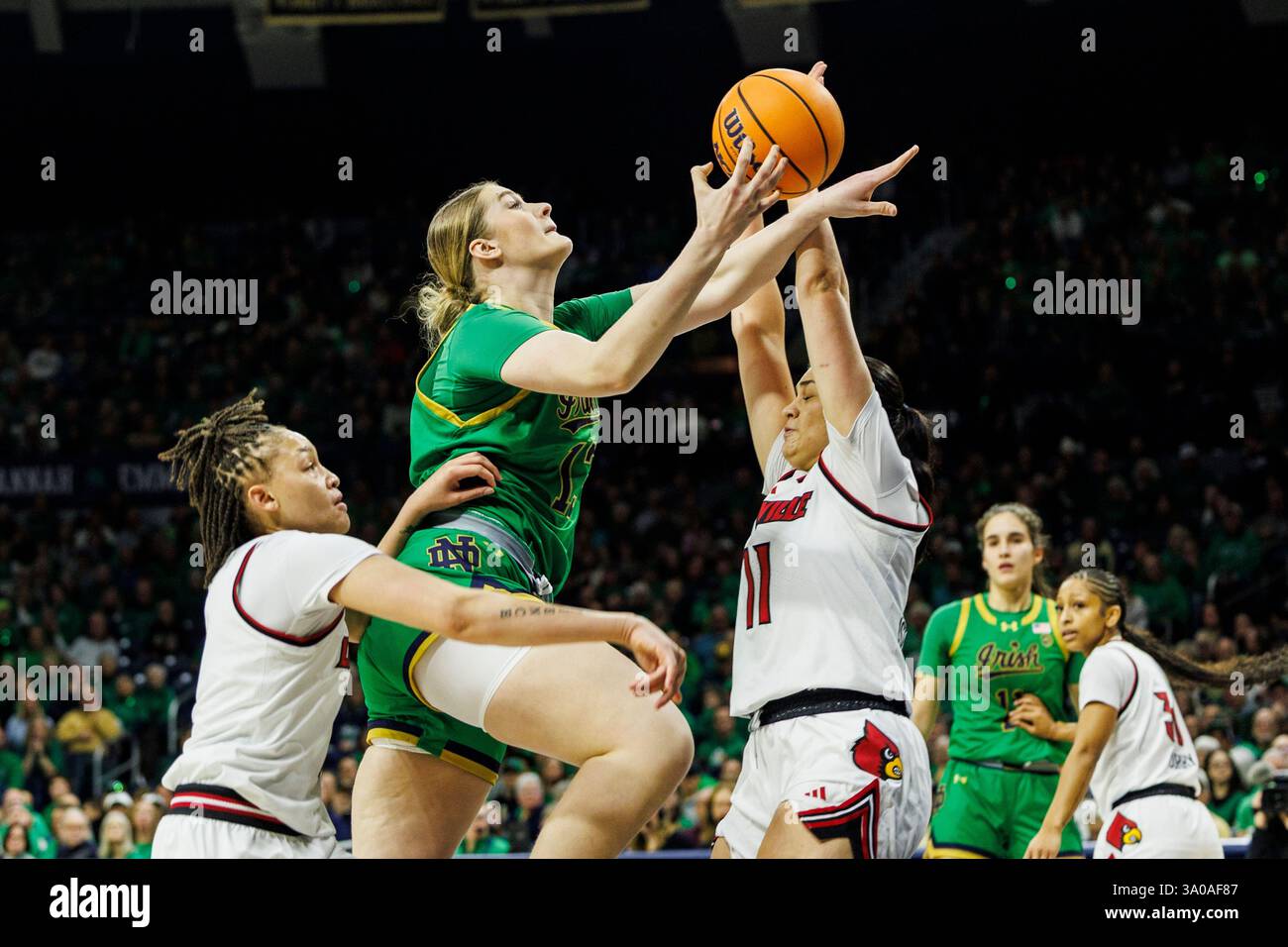 Notre Dame forward Kate Koval (13) shoots over Louisville forward Elif ...