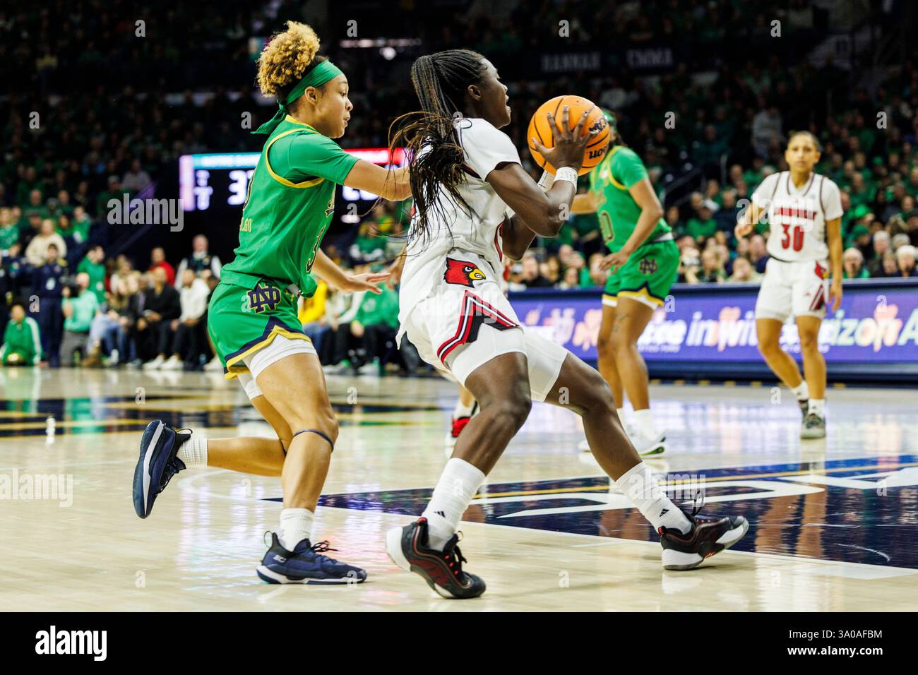 Louisville guard Ja'Leah Williams, right, drives around Notre Dame ...