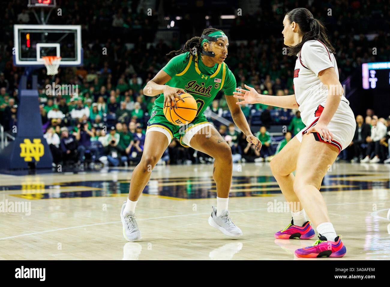 Notre Dame forward Liatu King (20) looks to drive as Louisville forward ...
